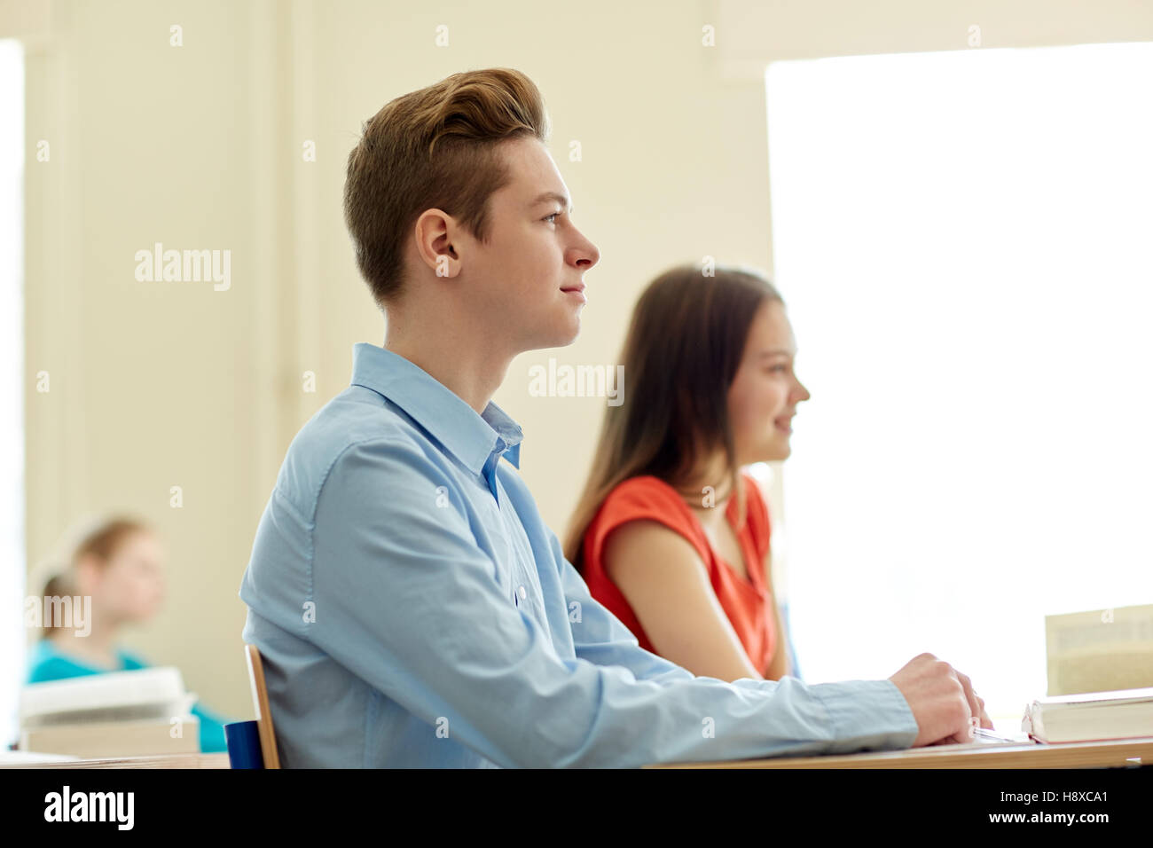 group of students with notebooks at school lesson Stock Photo - Alamy