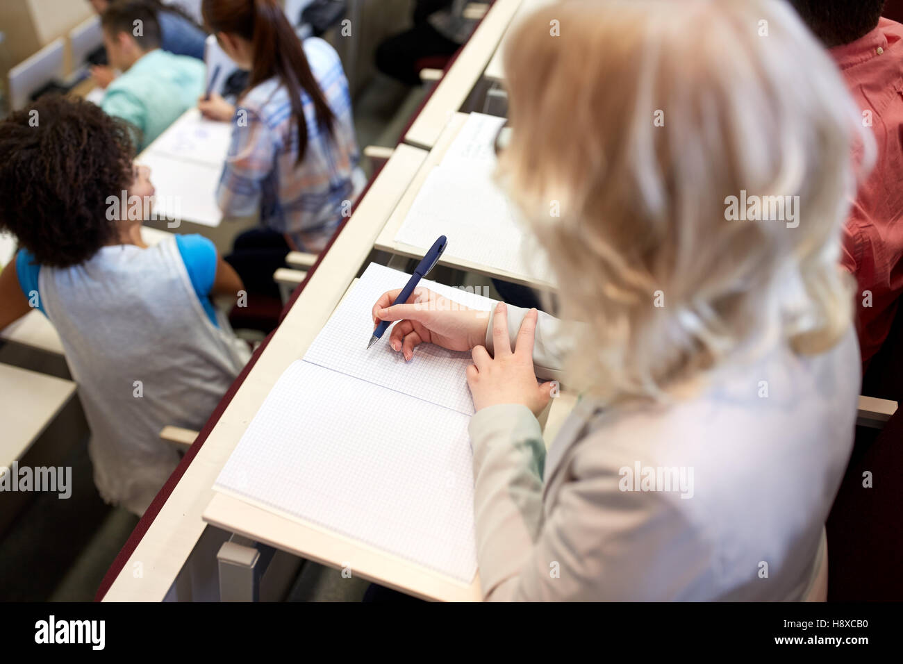 student writing to notebook at exam or lecture Stock Photo - Alamy