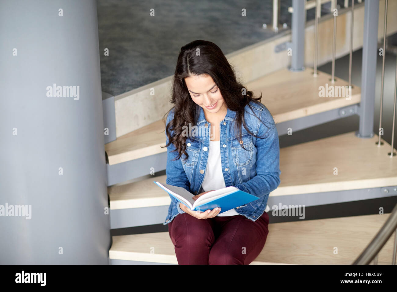 high school student girl reading book on stairs Stock Photo - Alamy