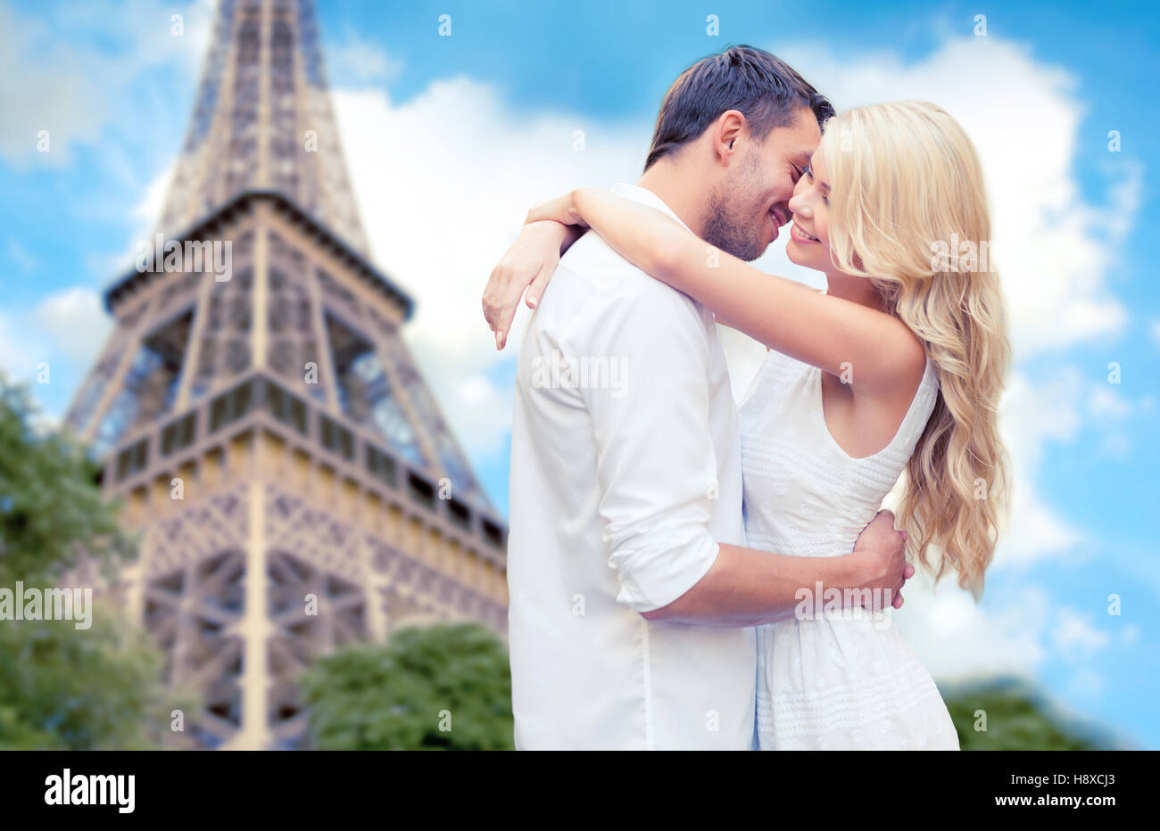 happy couple hugging over eiffel tower Stock Photo - Alamy