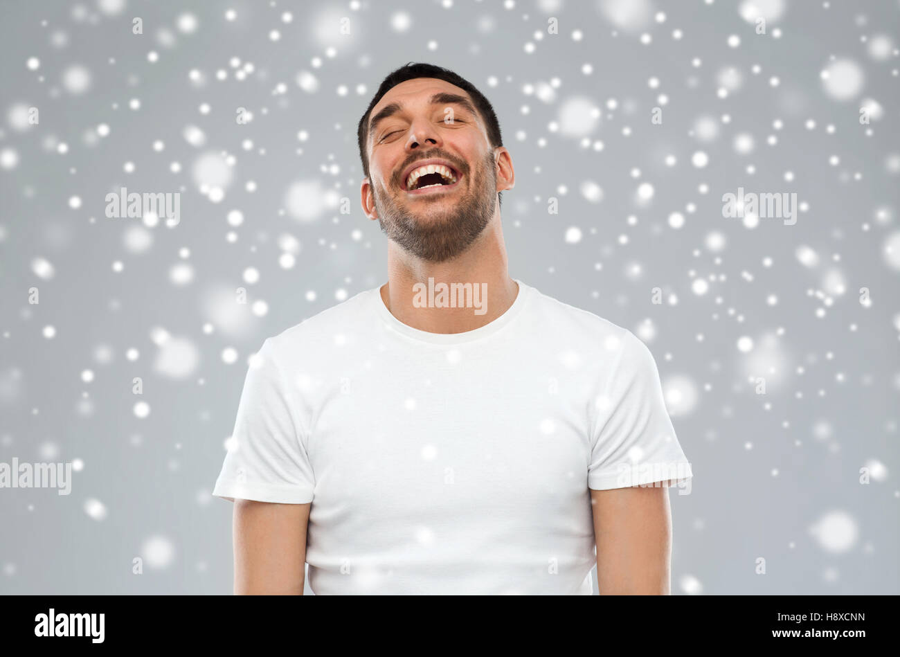 happy laughing man over snow background Stock Photo - Alamy