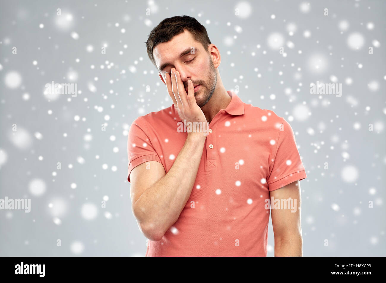 tired sleepy man over snow Stock Photo - Alamy