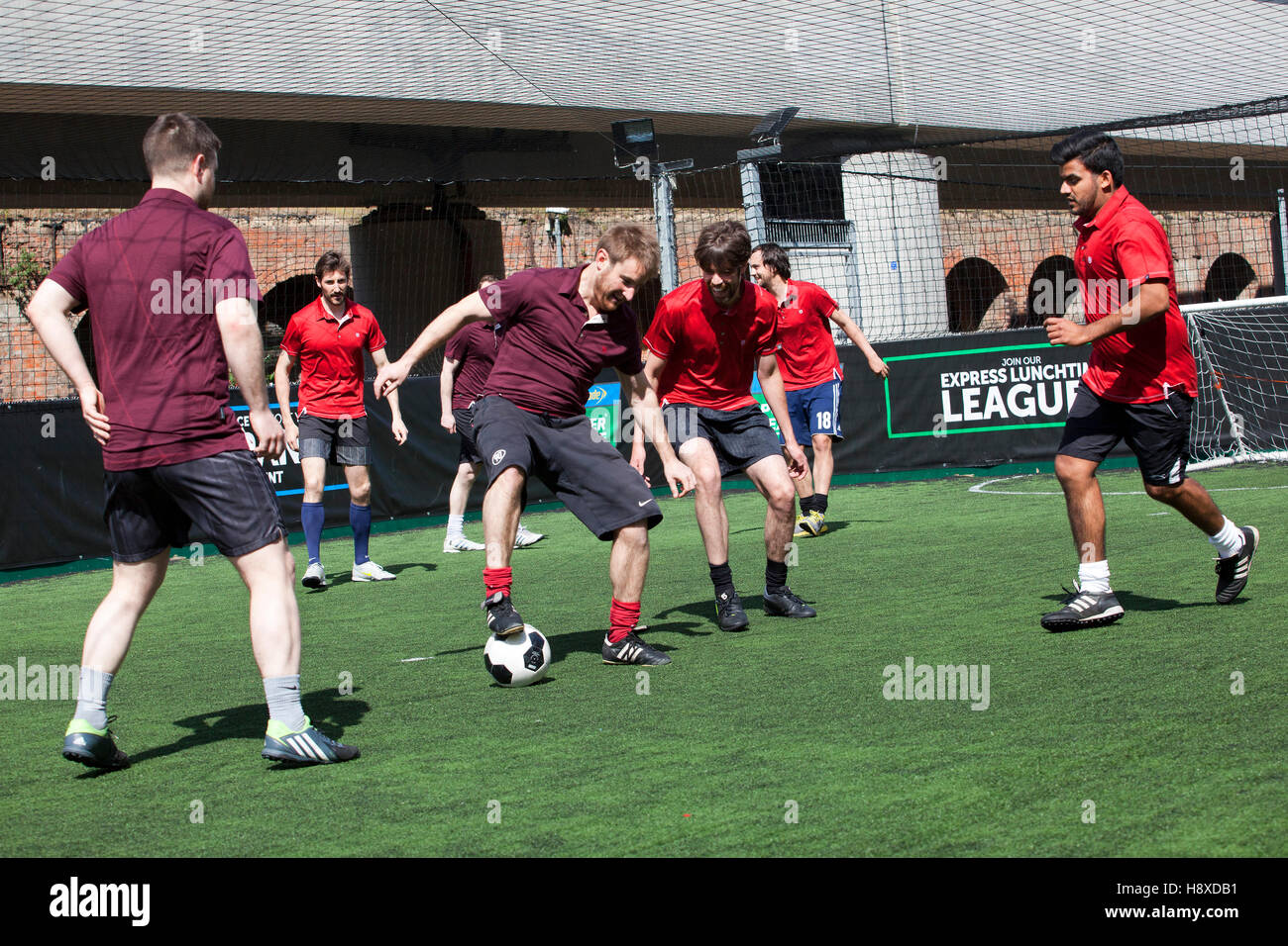 A men's football match in progress on an all weather pitch located in ...
