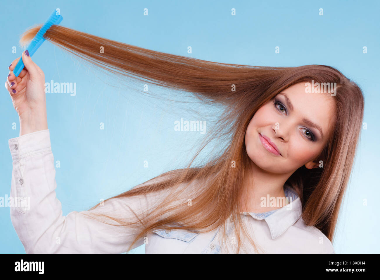 Care coiffure haidressing professional beauty concept. Girl with comb ...