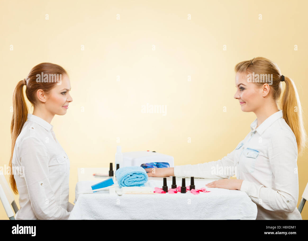 Manicure process concept. Young beautician and woman customer in beauty ...