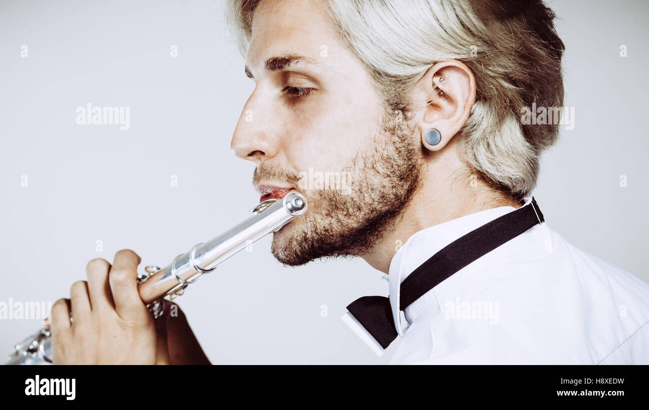 Flute music playing professional male flutist musician performer. Young ...