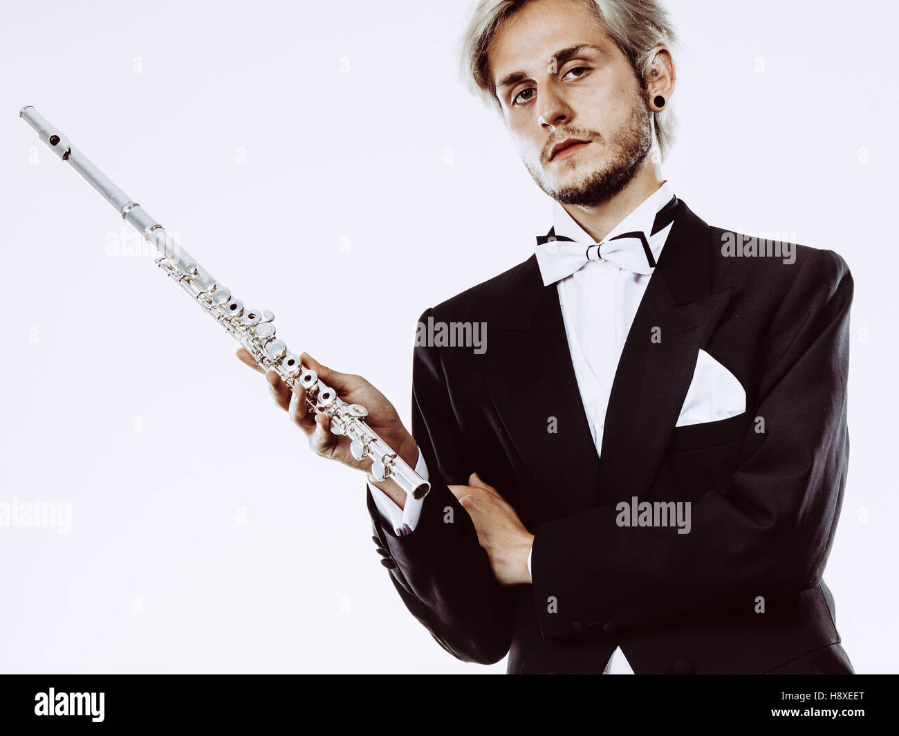Classical music study concept. Male flutist musician performer playing ...