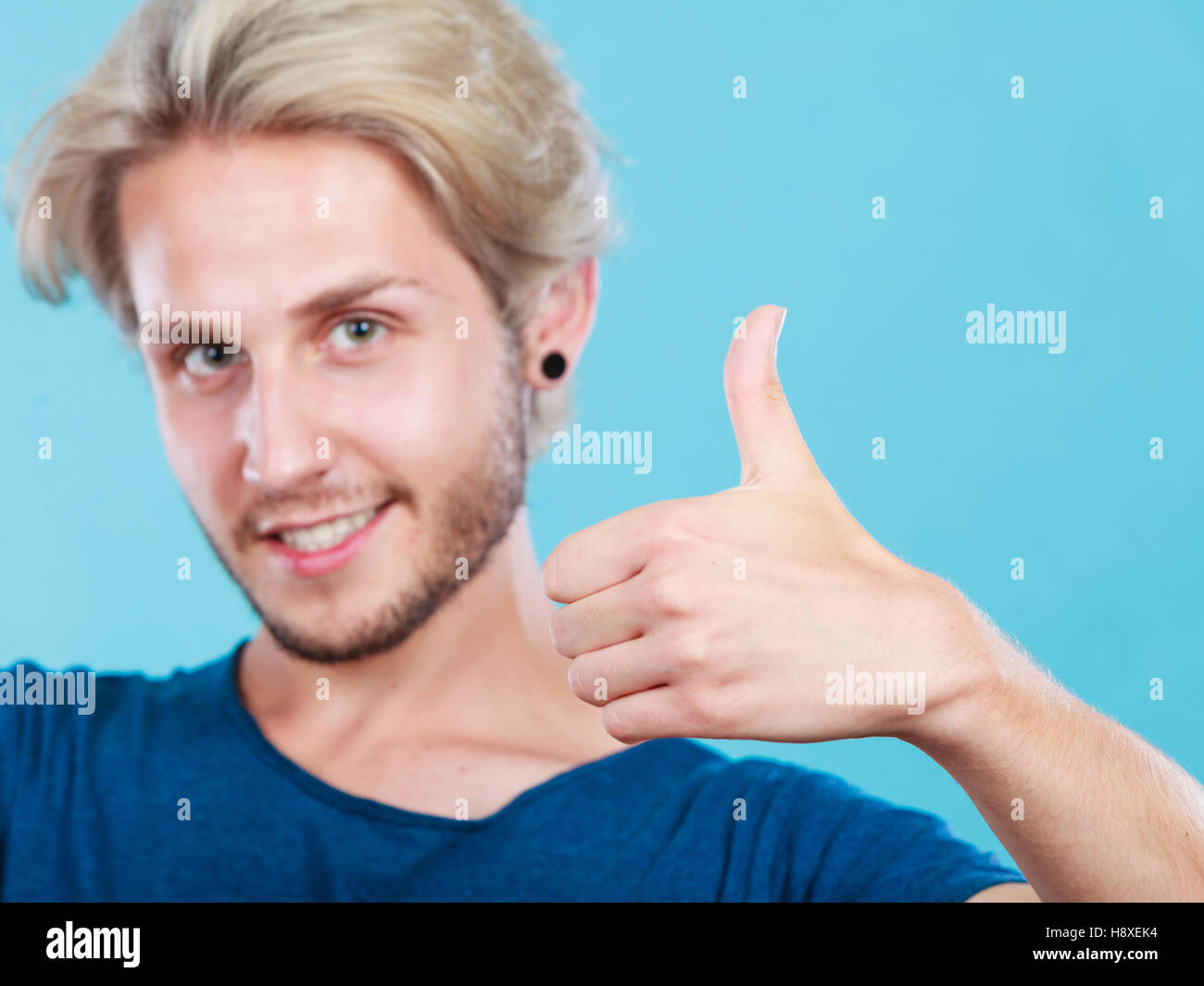 Success positive emotion concept. Young college student giving thumb up ...