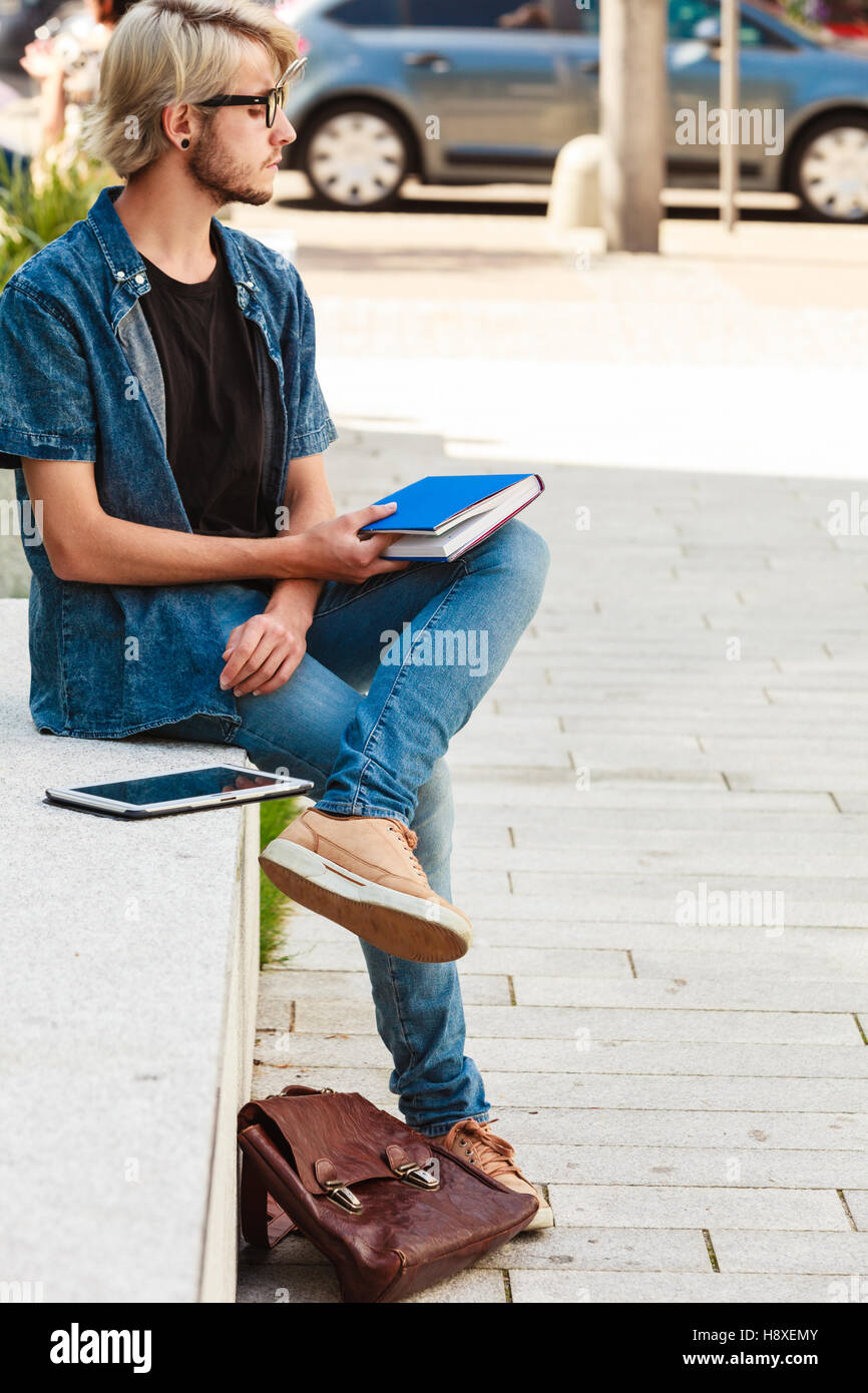 Male fashion, student concept. Guy holding notebook wearing jeans ...