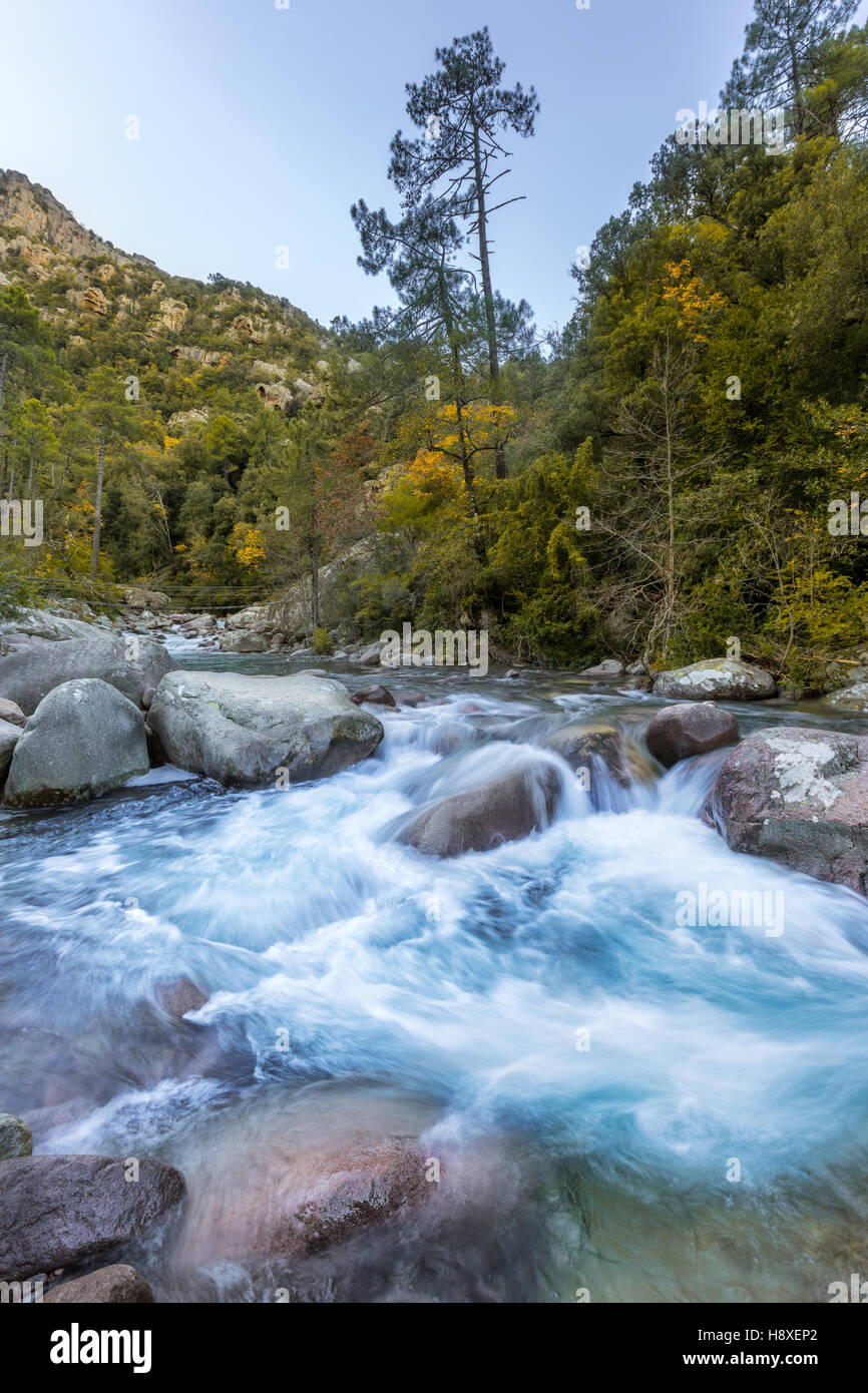 Slow shutter image of the cascading Figarella river flowing over rocks ...
