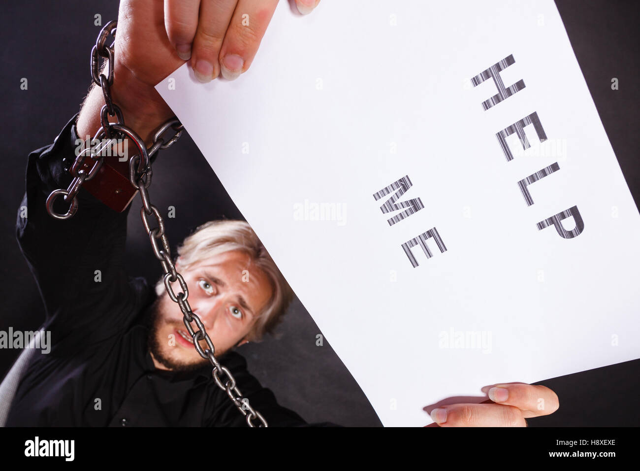 Stress, depression, assistance concept. Scared man with chained hands ...