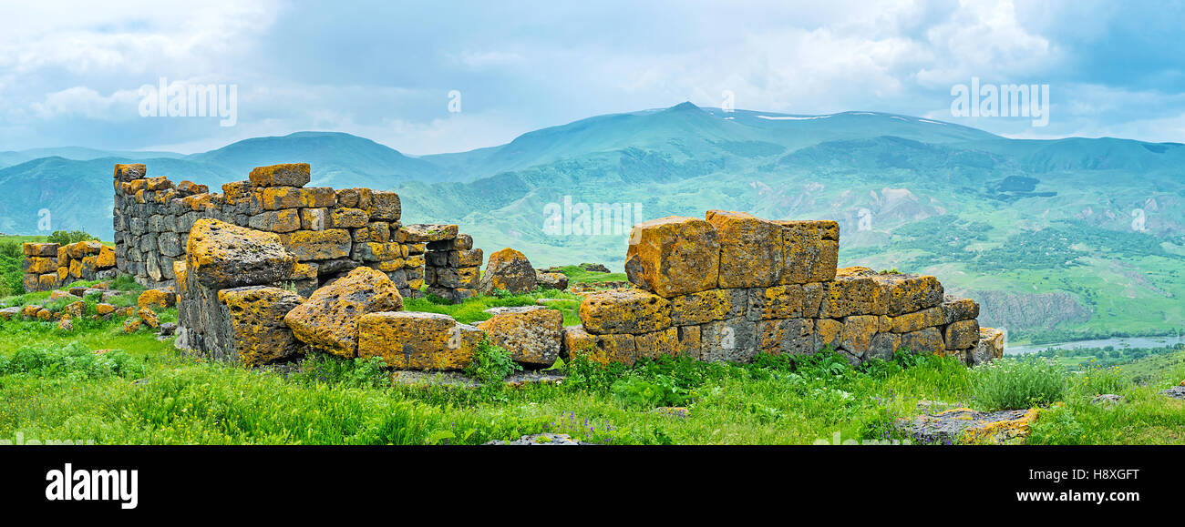 The wall of megalithic fortress among the green grass in Saro, Georgia ...