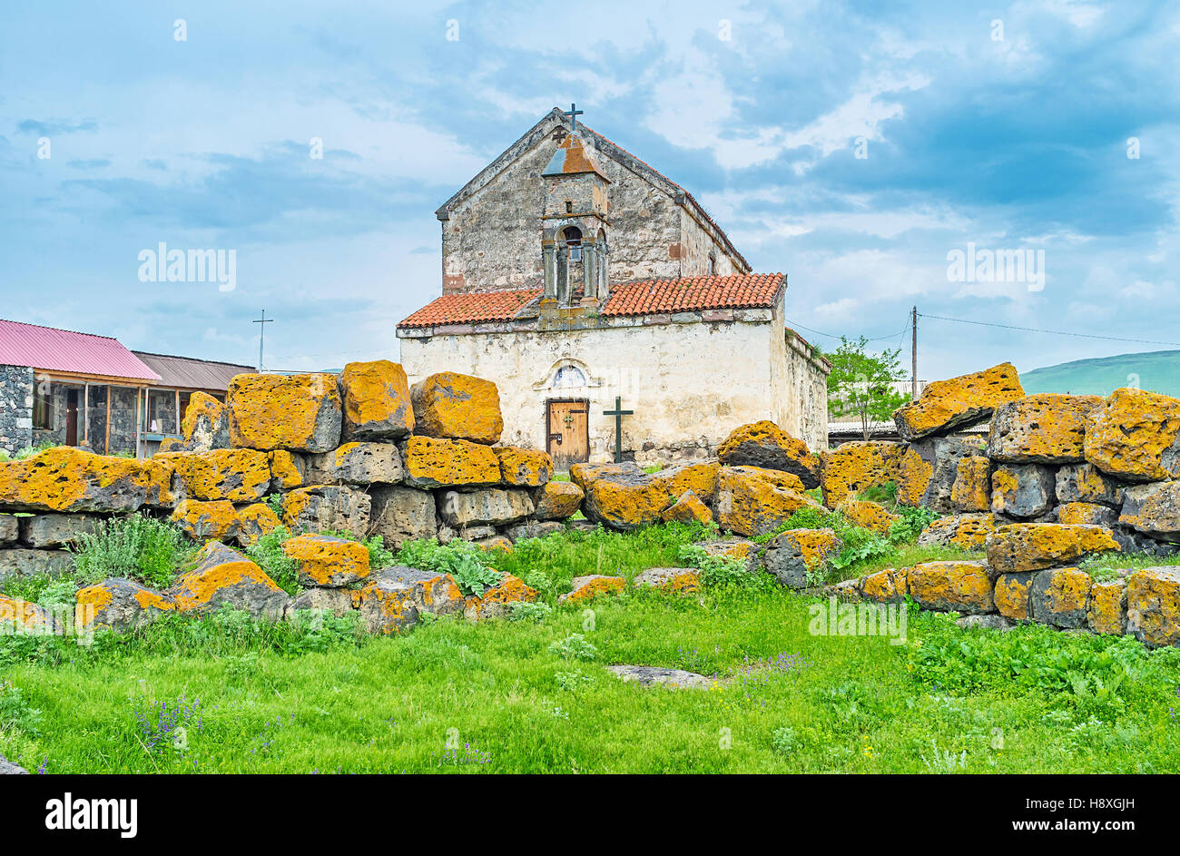 The church of the small village monastery with ruins of the megalithic ...