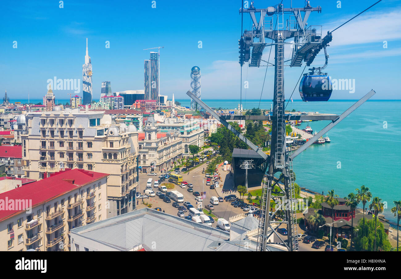 The cableway tower and the blue lift with the hotels and skyscrapers of ...