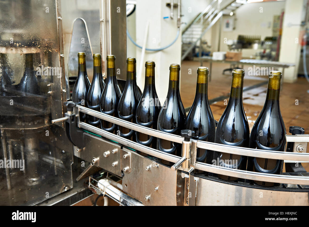 Bottling and sealing conveyor line at winery factory Stock Photo - Alamy