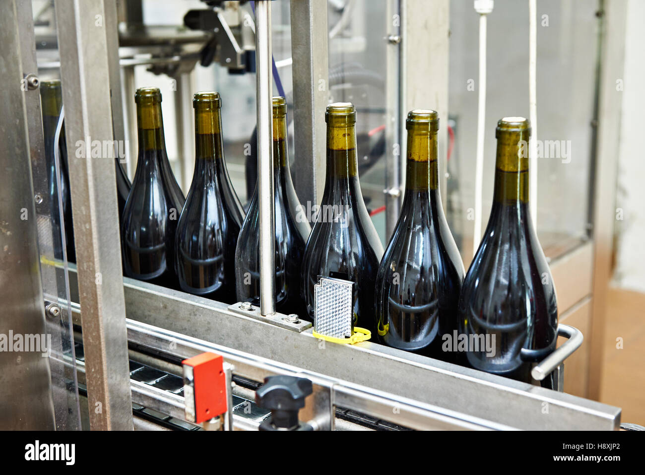 Bottling and sealing conveyor line at winery factory Stock Photo - Alamy