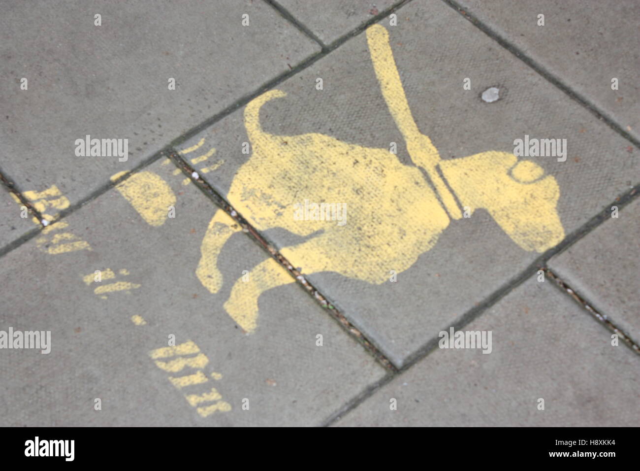 bag it - bin it graffiti art - yellow spray painted dog Stock Photo - Alamy