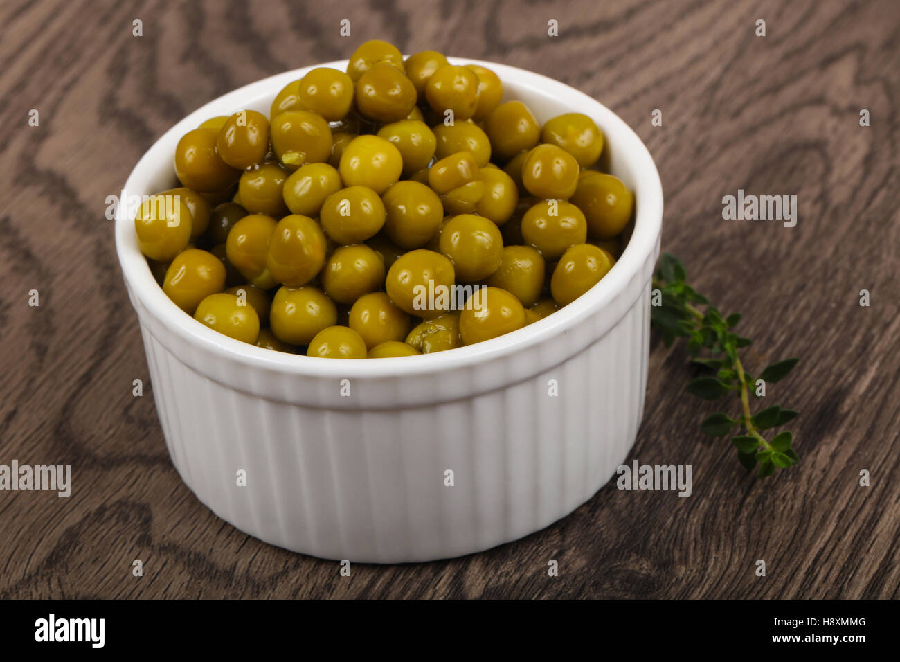 Pickled pea in the plate over wooden background Stock Photo - Alamy