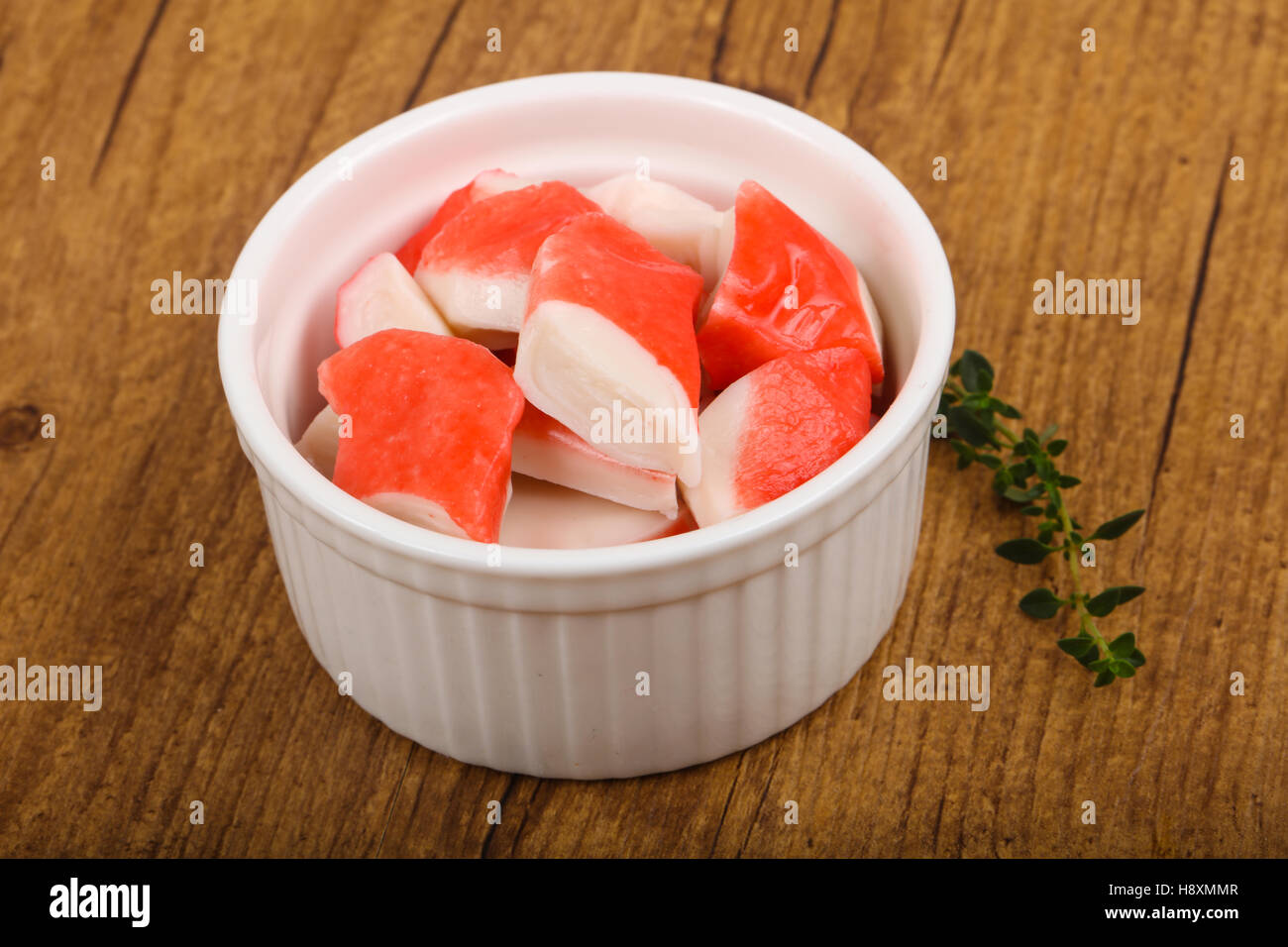 Crab stick - surimi in the plate - over wood background Stock Photo - Alamy
