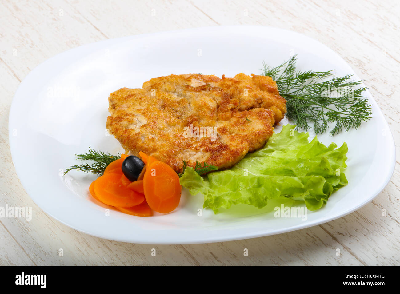 Chicken schnitzel served salad leaves and dill Stock Photo - Alamy