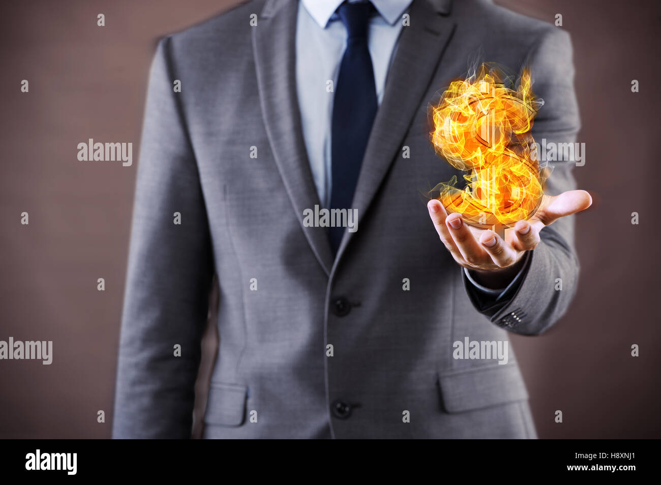 Businessman holding burning american dollar sign Stock Photo - Alamy