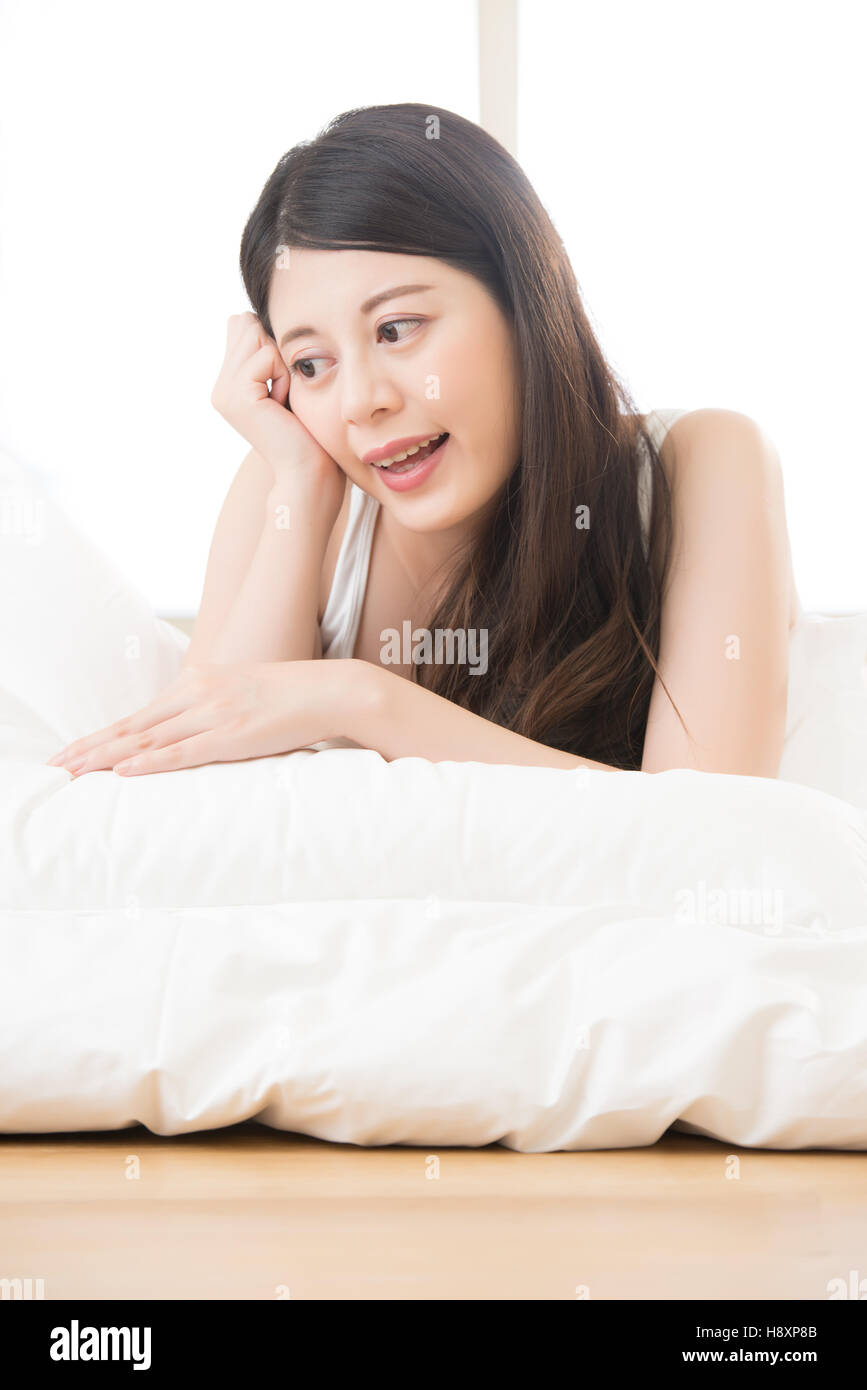 happy beautiful health asian woman feel carefree lying on bed in ...