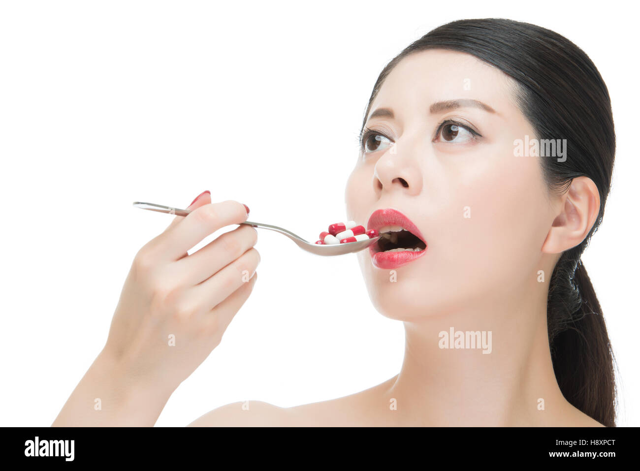 asian woman use spoon taking numerous of medicine pill, isolated on ...