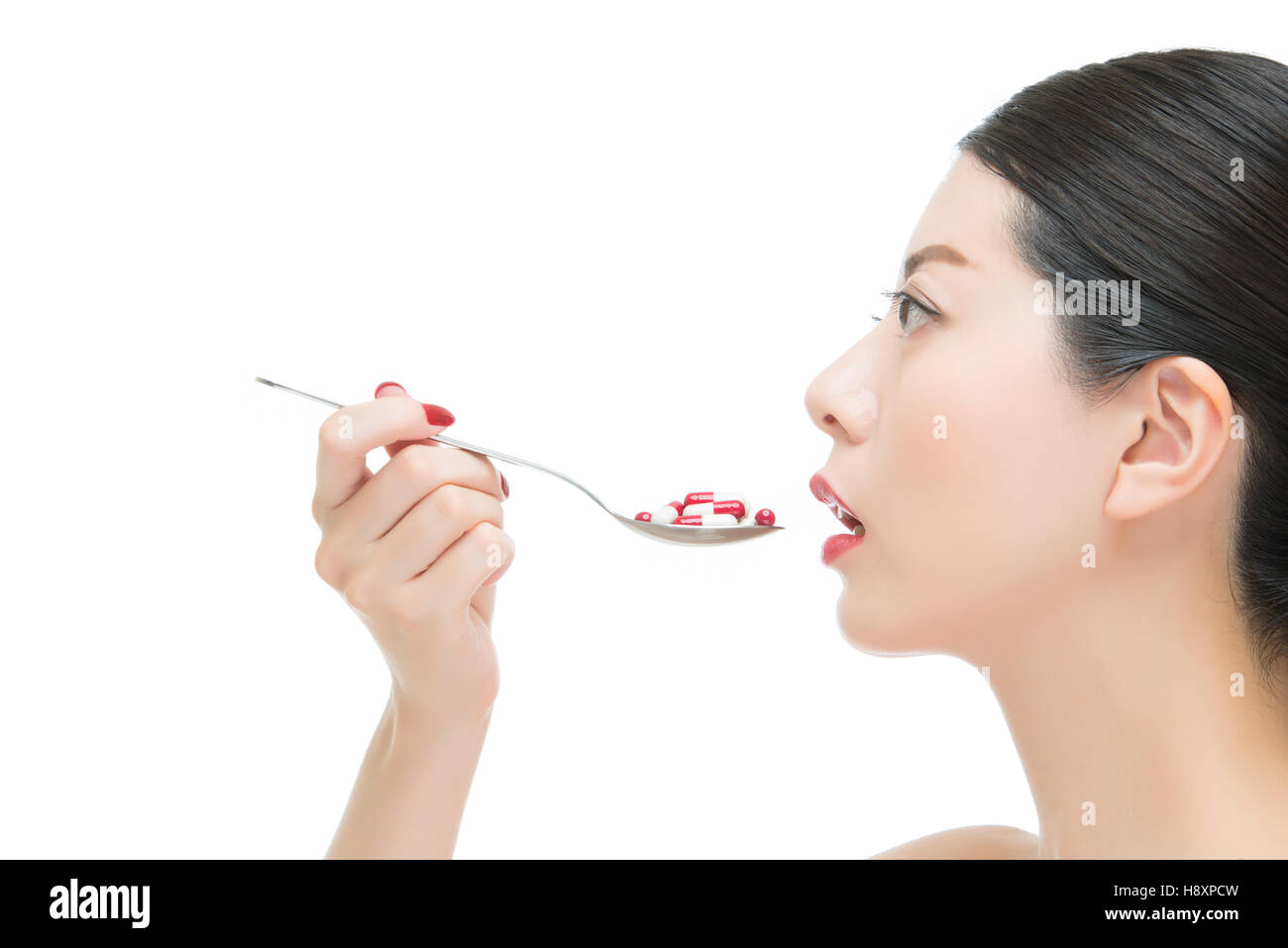 asian woman use spoon taking numerous of medicine pill, isolated on ...