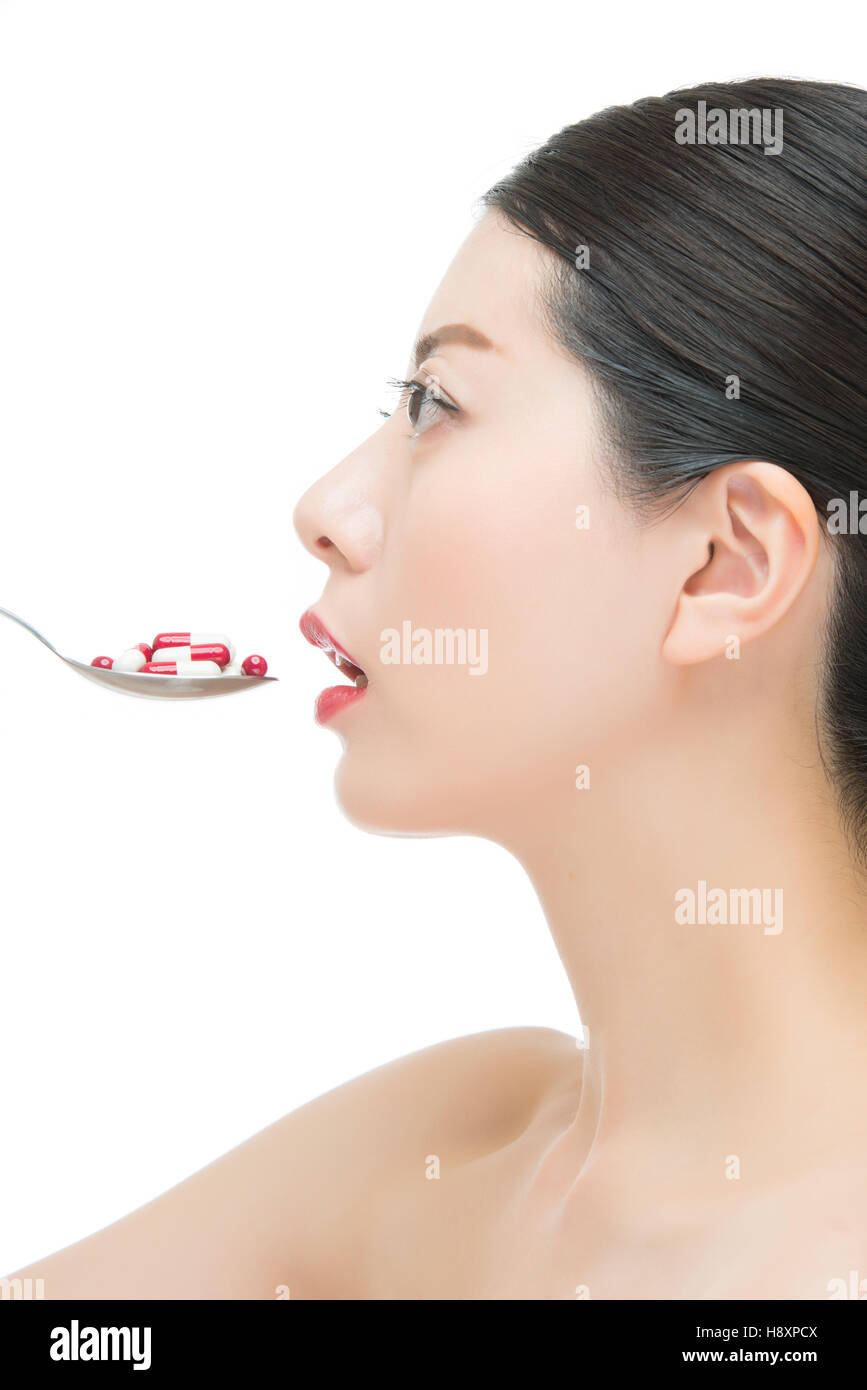asian woman use spoon taking numerous of medicine pill, isolated on ...
