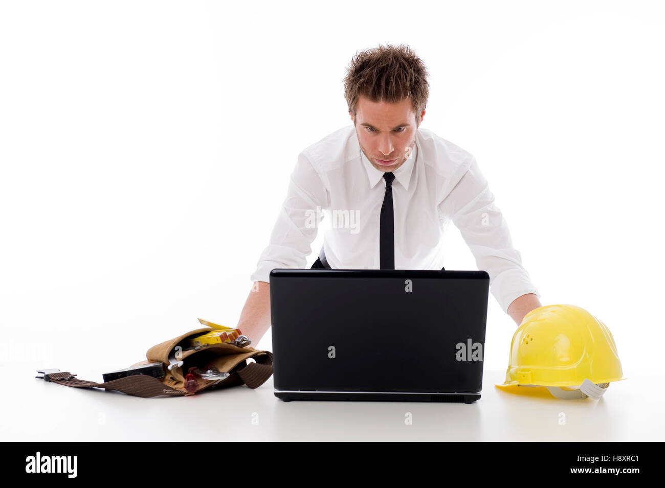 Businessman with tools and laptop Stock Photo - Alamy