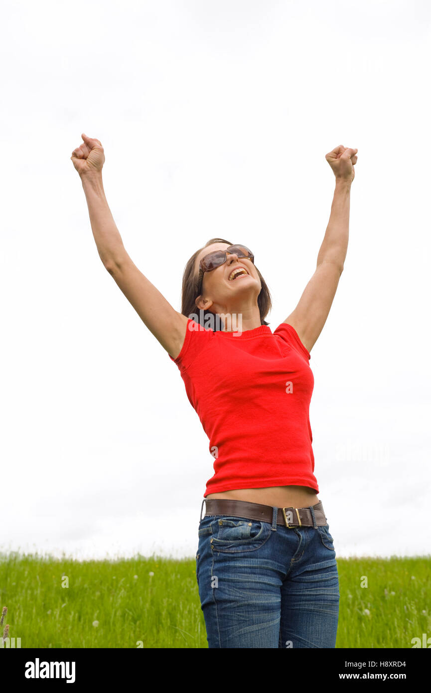 Euphoric woman, 30, on a lawn in spring Stock Photo - Alamy
