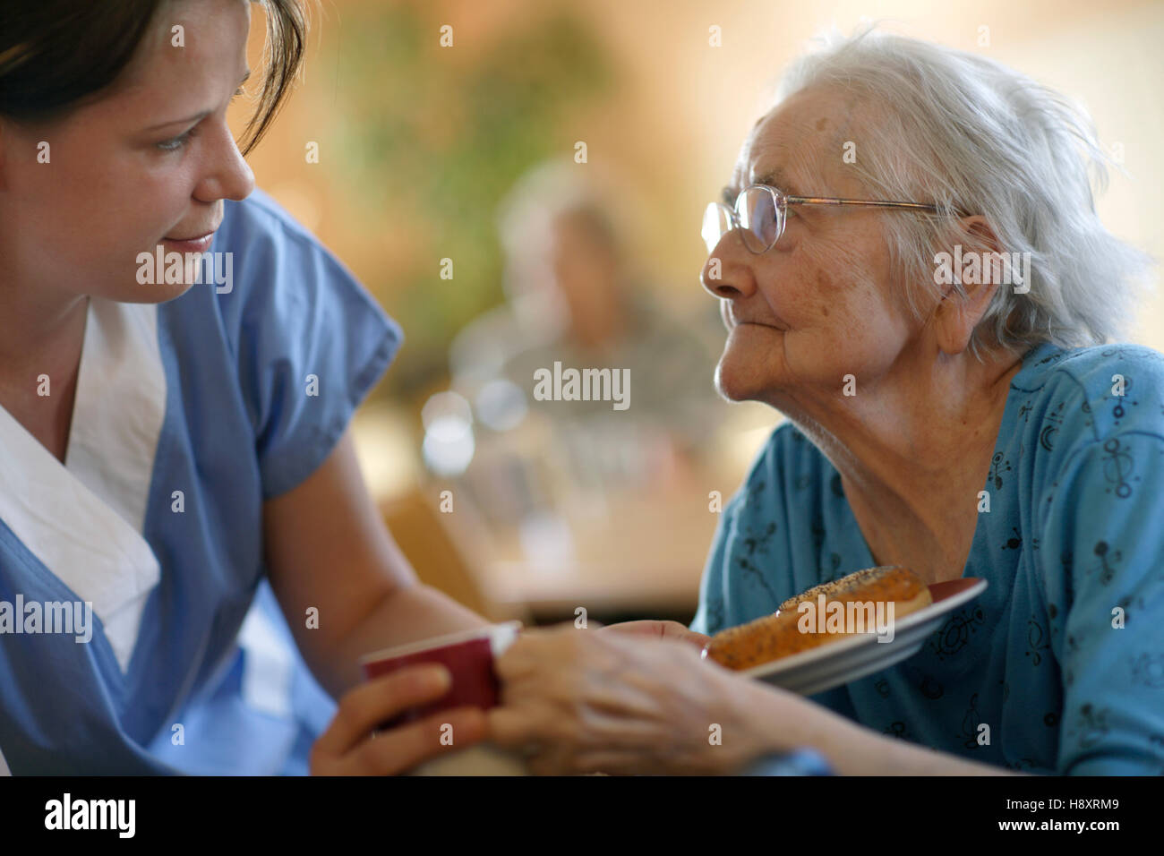 Nursing home, elderly woman with a nurse Stock Photo - Alamy