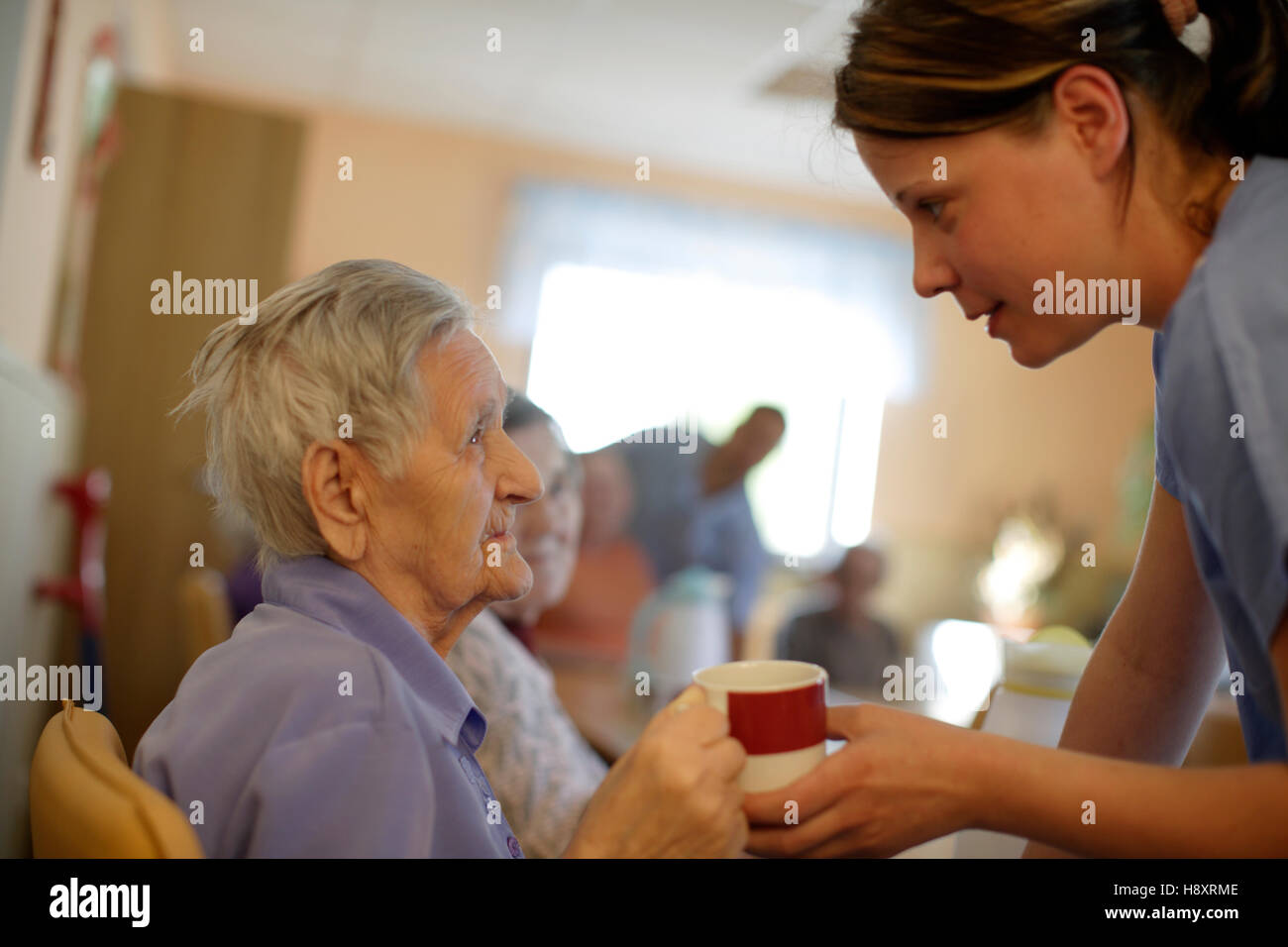 Nursing home, elderly woman with a nurse Stock Photo - Alamy