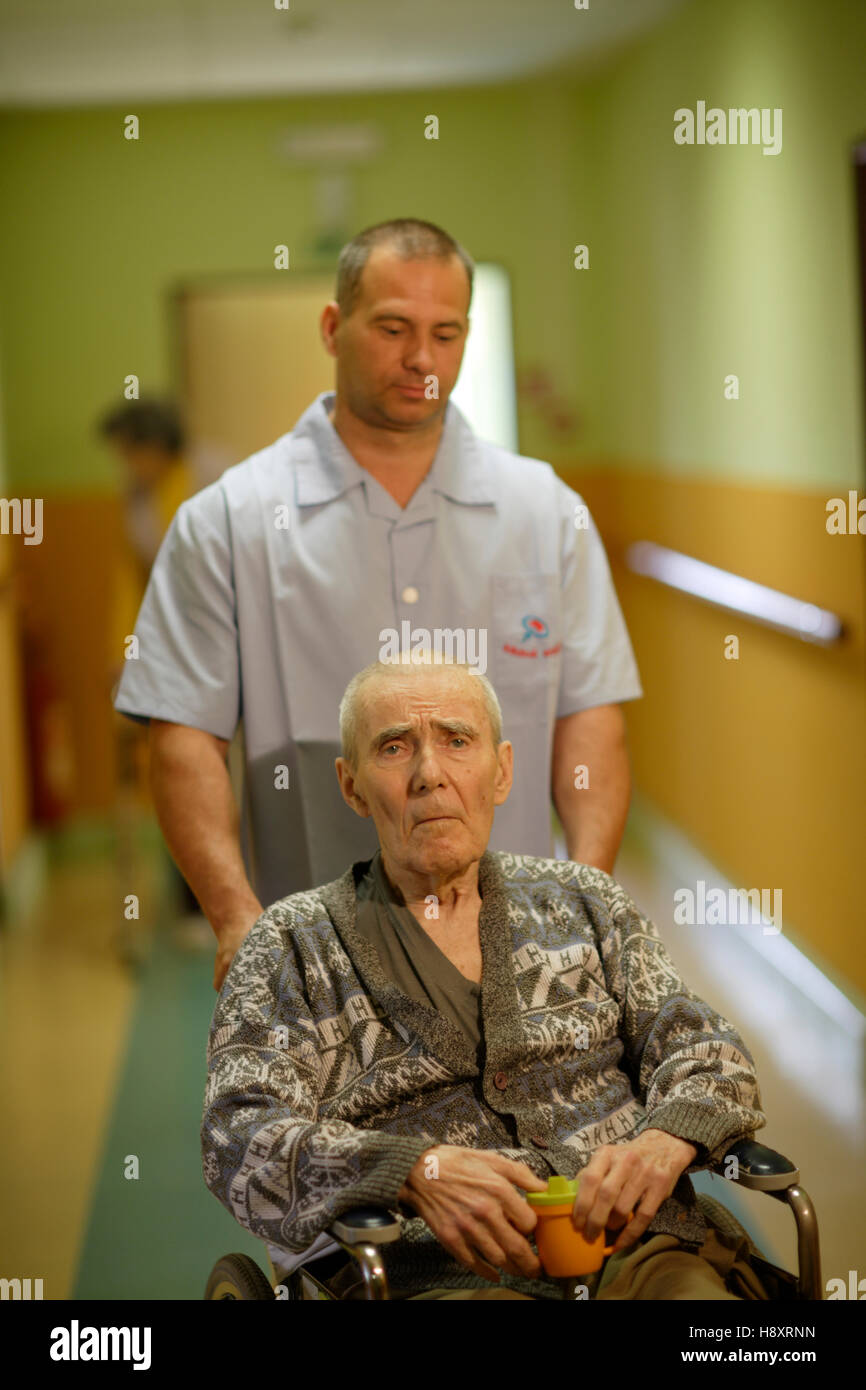 Nursing home, elderly man with a male nurse Stock Photo - Alamy