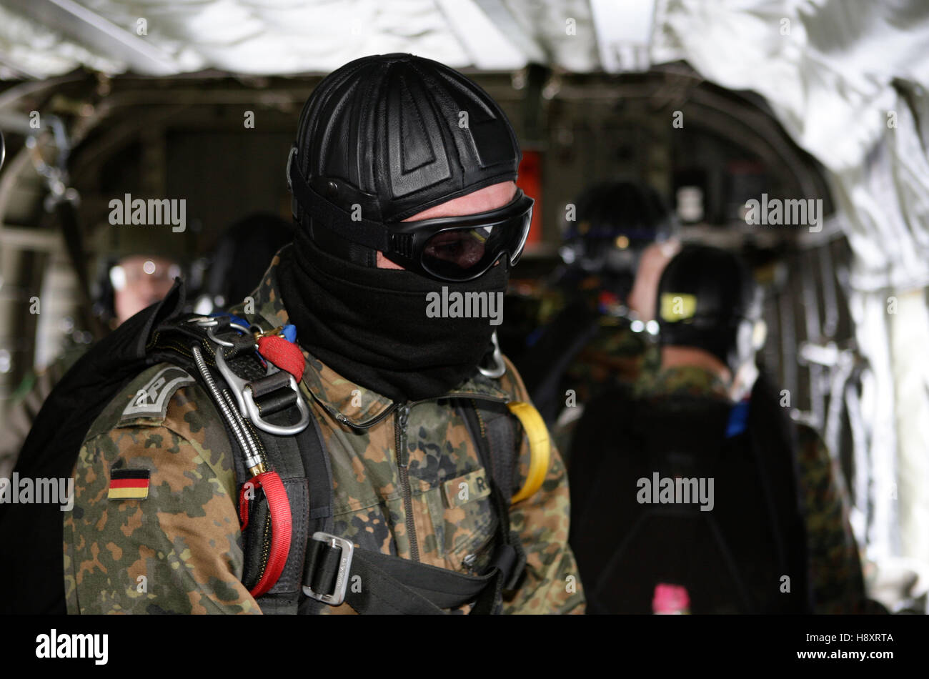 Paratrooper wearing face mask and goggles in a helicopter just before ...