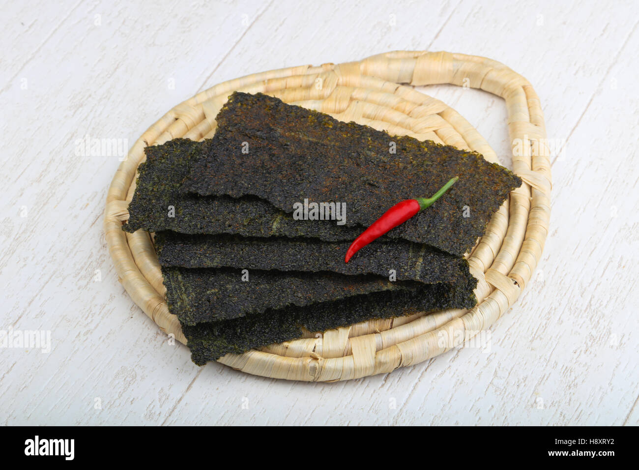 Spicy Nori seaweed sheets with pepper on wood Stock Photo - Alamy
