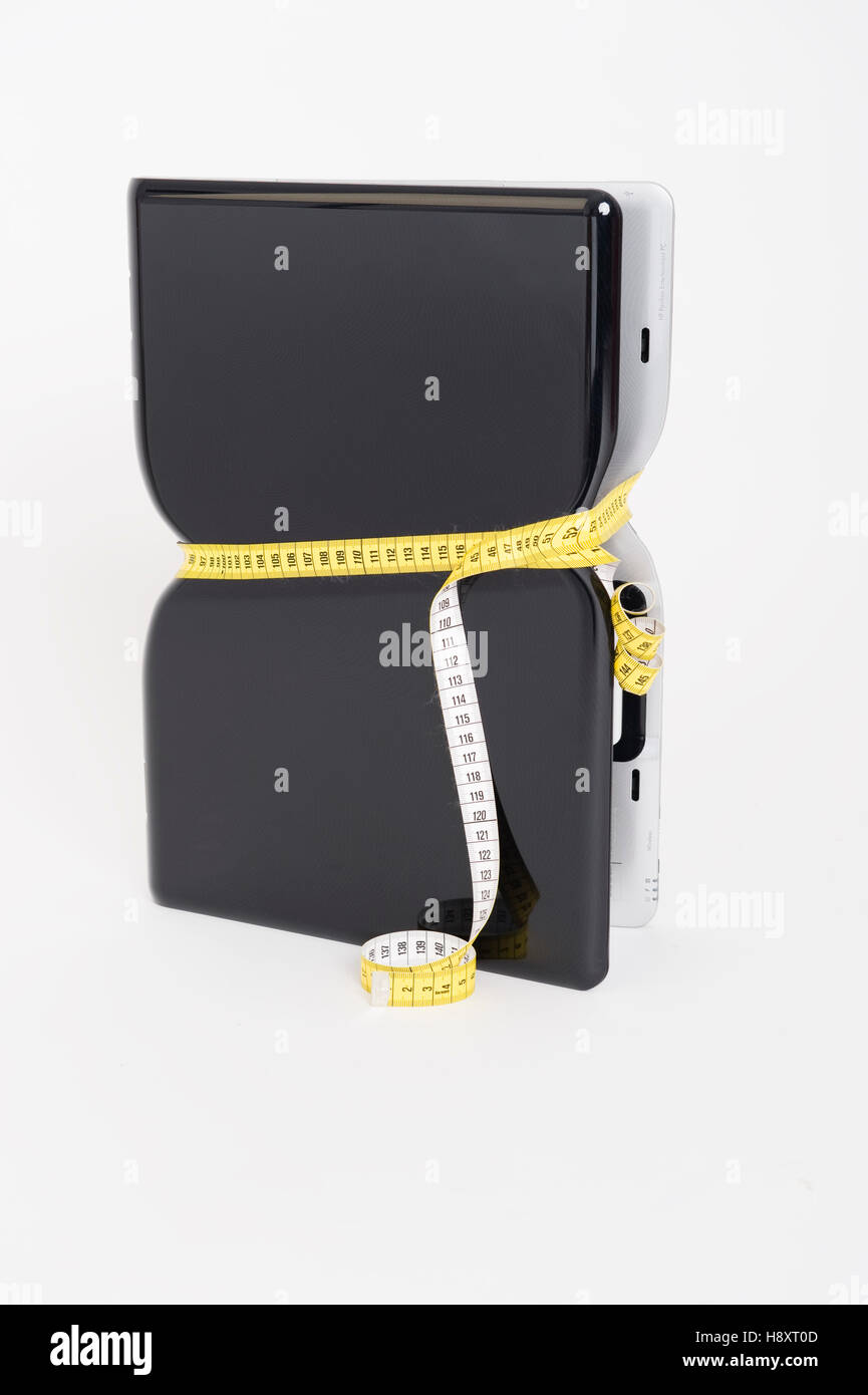 Small laptop, tied up with measuring tape Stock Photo - Alamy