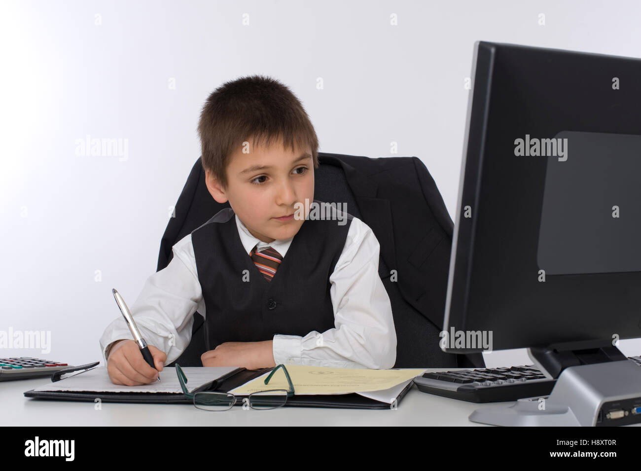 Boy dressed as a businessman in an office Stock Photo - Alamy