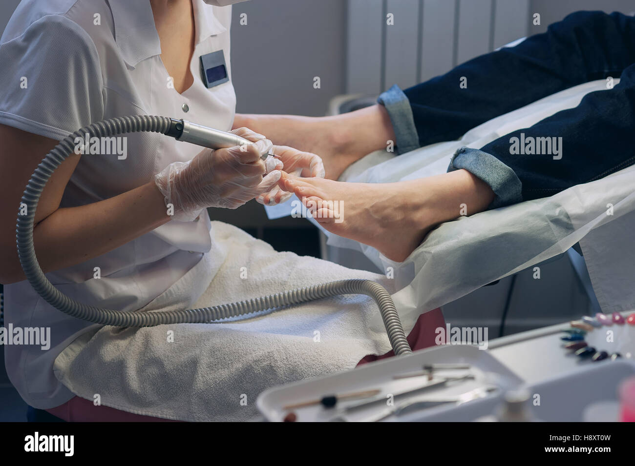 profesional nail technician sanding nails with machine Stock Photo - Alamy