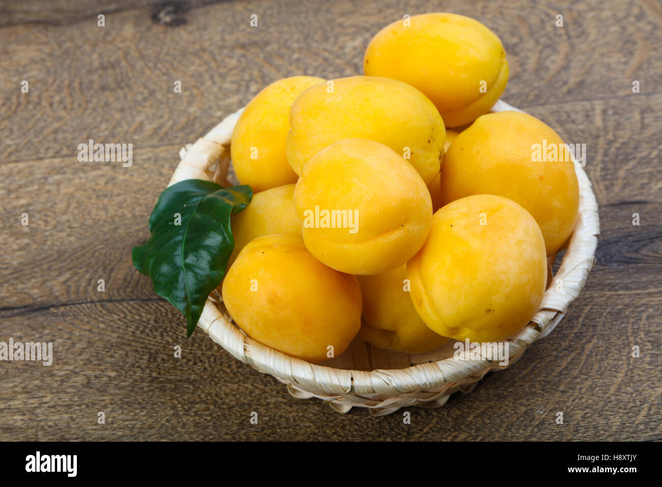 Fresh ripe sweet yellow apricots on the wood background Stock Photo - Alamy