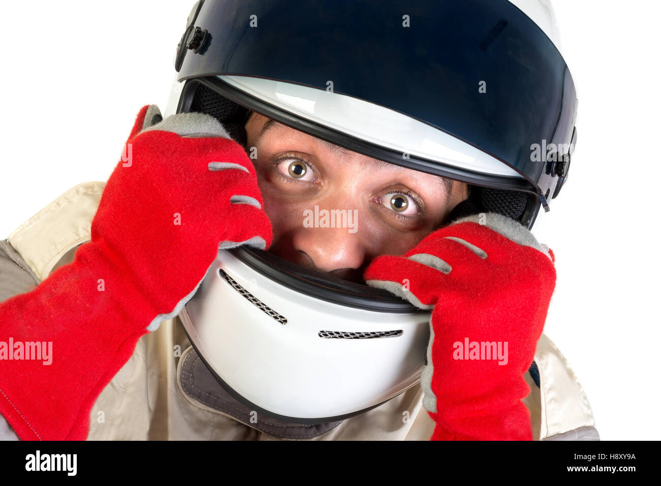 Racing driver posing with helmet isolated in white Stock Photo - Alamy