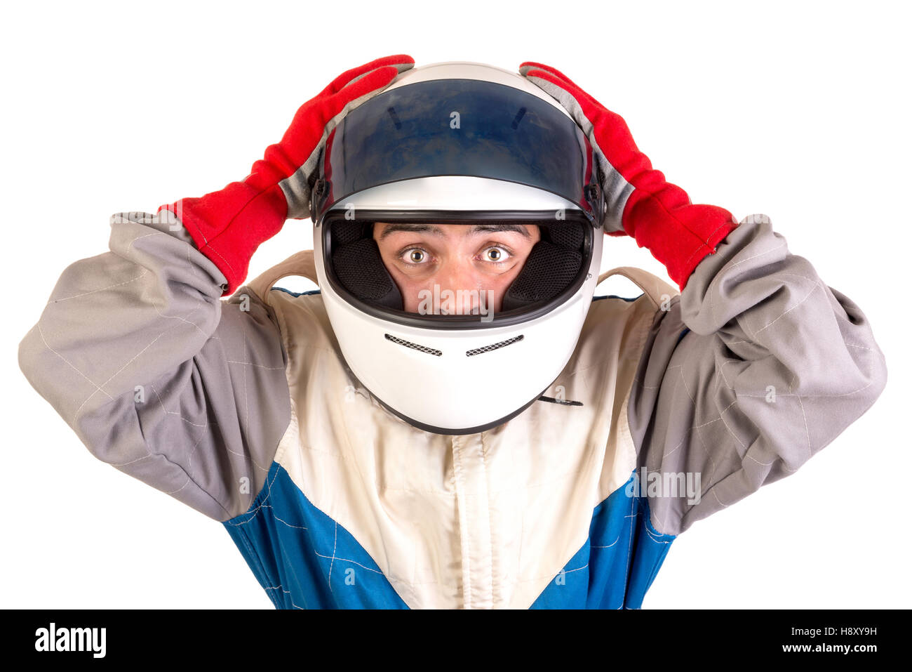 Racing driver posing with helmet isolated in white Stock Photo - Alamy