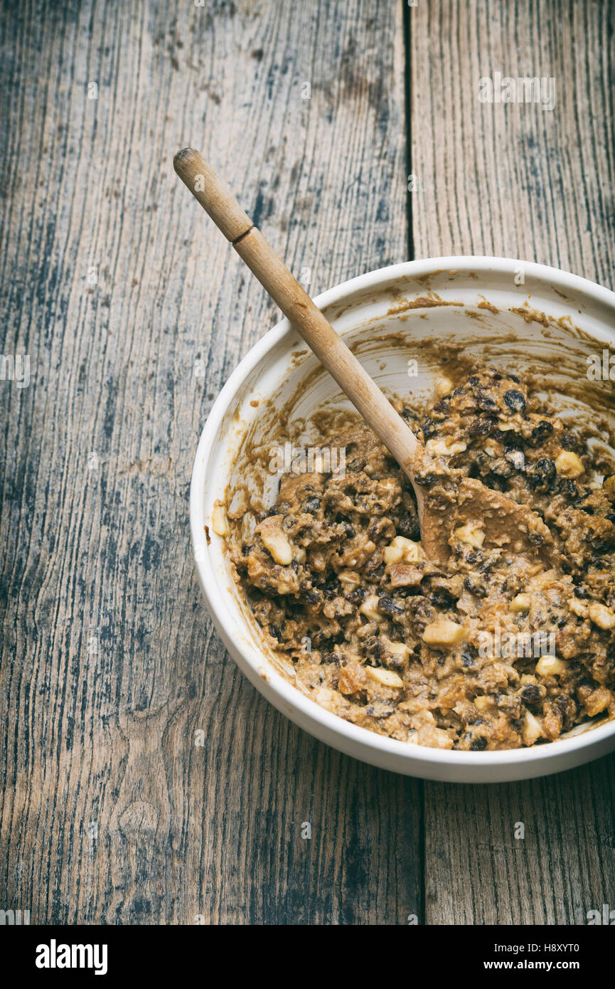 Christmas pudding mixture in a bowl with a wooden spoon. Stir up sunday ...