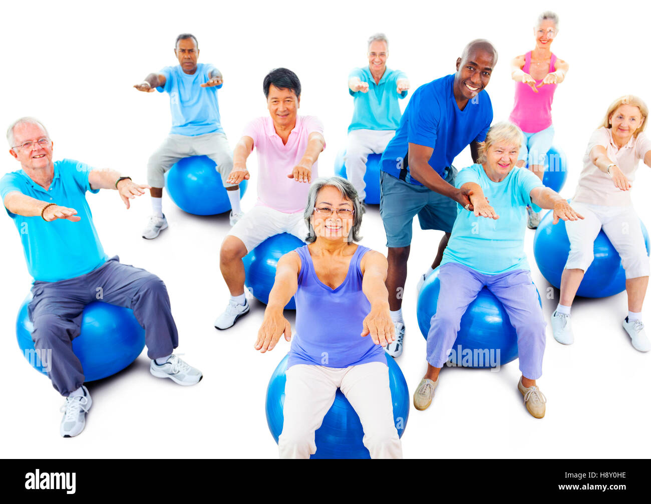 Group Of Multi-Ethnic Senior Adults Exercising Yoga Concept Stock Photo ...