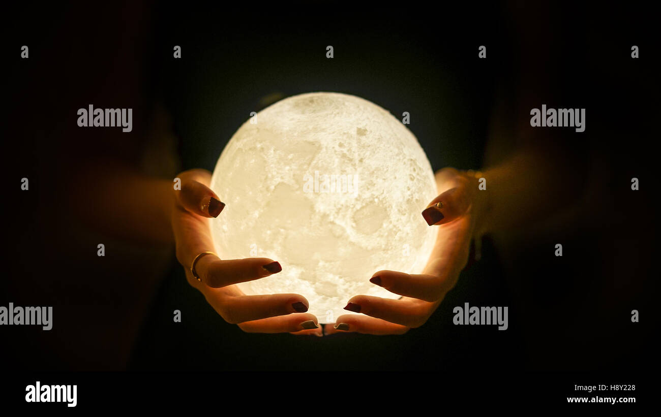 Moon in hands Stock Photo - Alamy