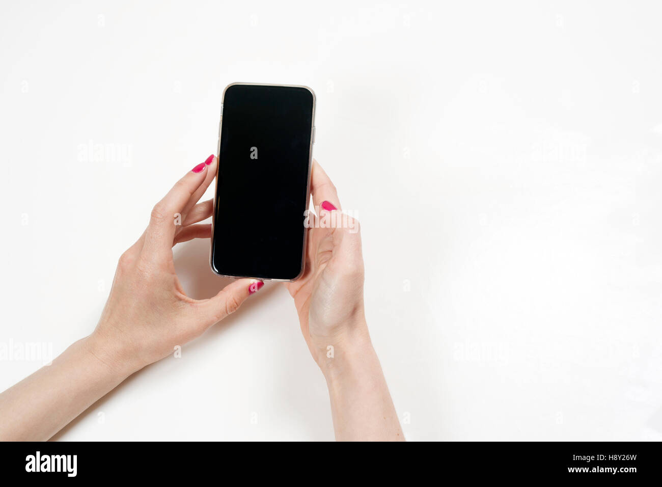 Mobile phone in a woman's hand Stock Photo - Alamy