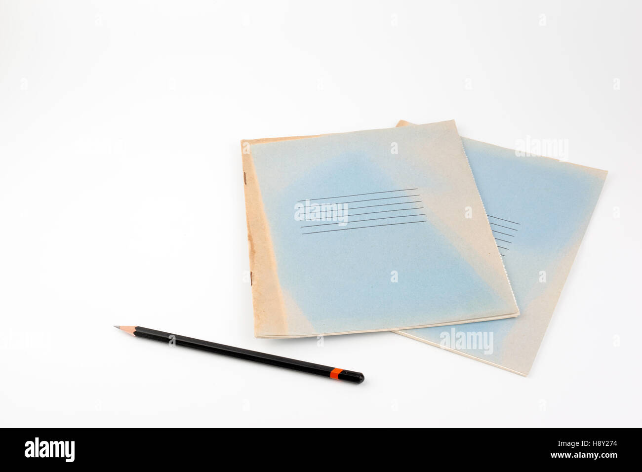 Old notebooks and black pencil - Free place for text Stock Photo - Alamy