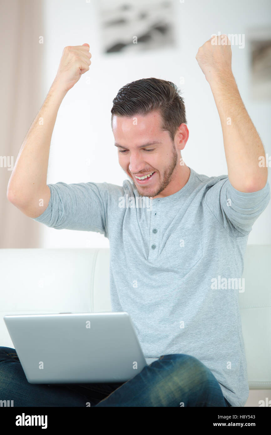 man with laptop computer looking at screen excited and happy Stock ...