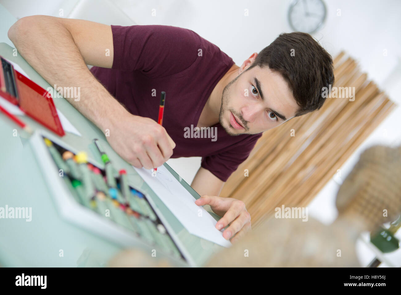 young man drawing pictures in studio Stock Photo - Alamy