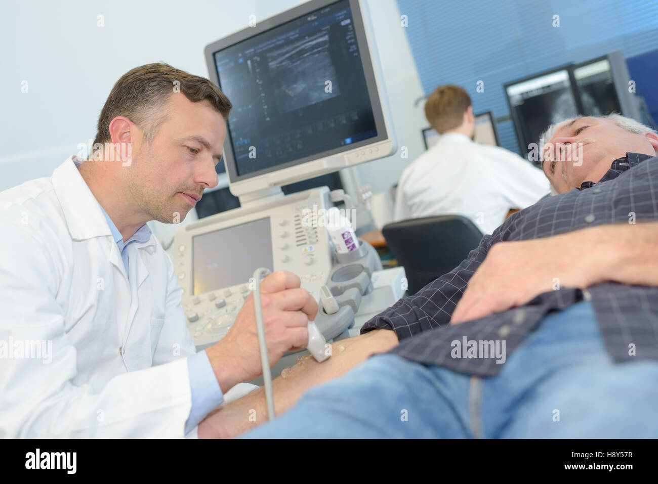 old man getting ultrasound from doctor in hospital Stock Photo - Alamy